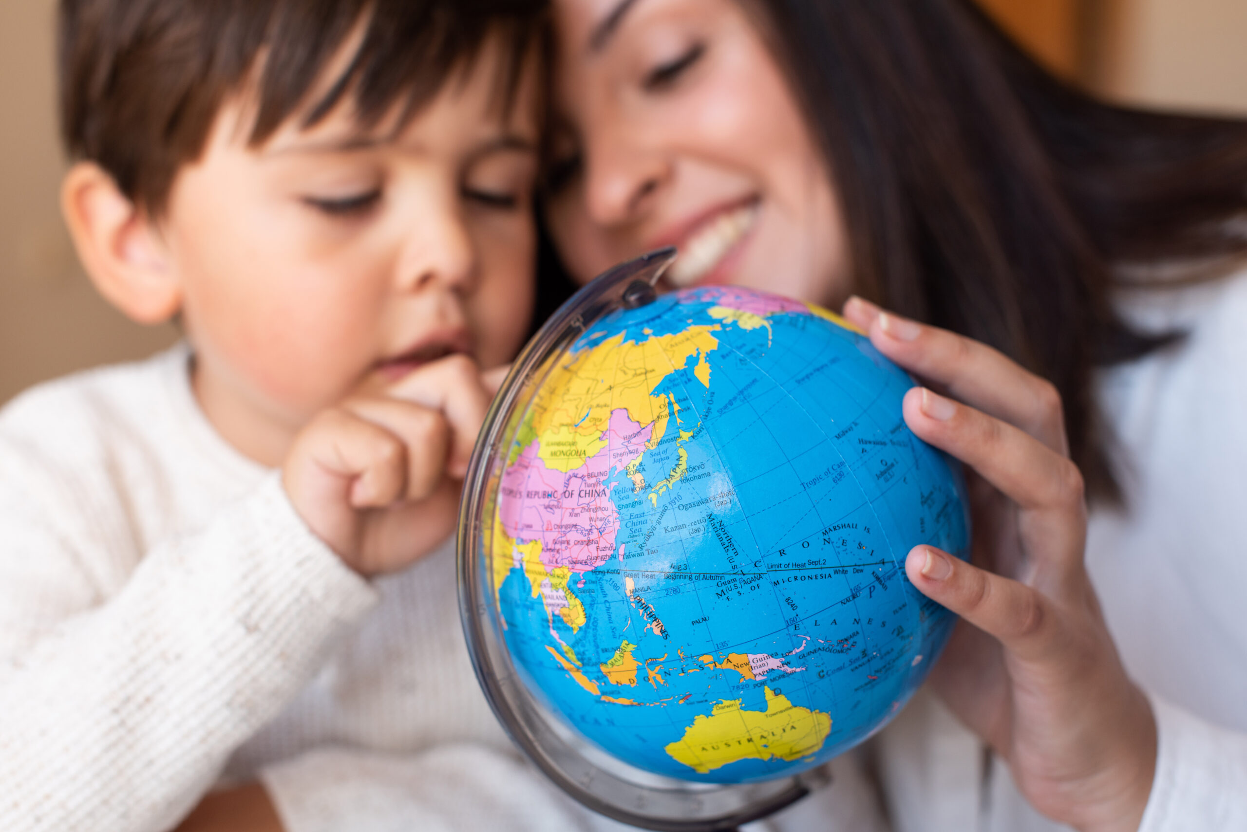 Preschooler Kid learing geography with a globe map and teacher e ...