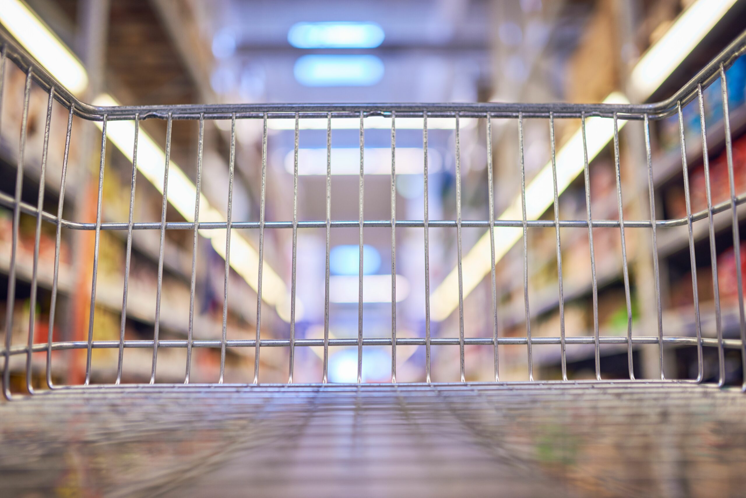 Abstract blurred photo of empty trolley in supermarket bokeh background ...